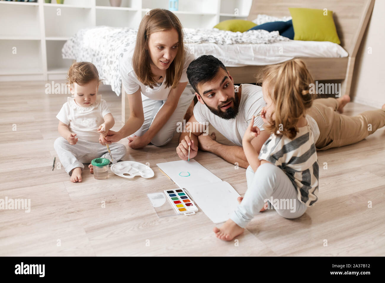 cheerful parents teaching their children to draw. Education.lifestyle ...