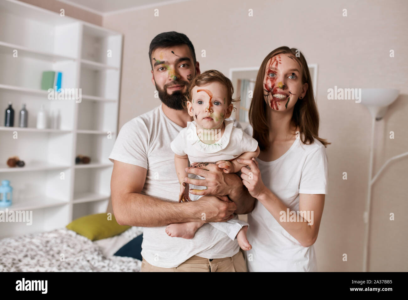 funny crazy young family woth painted colorful faces posing to the ...