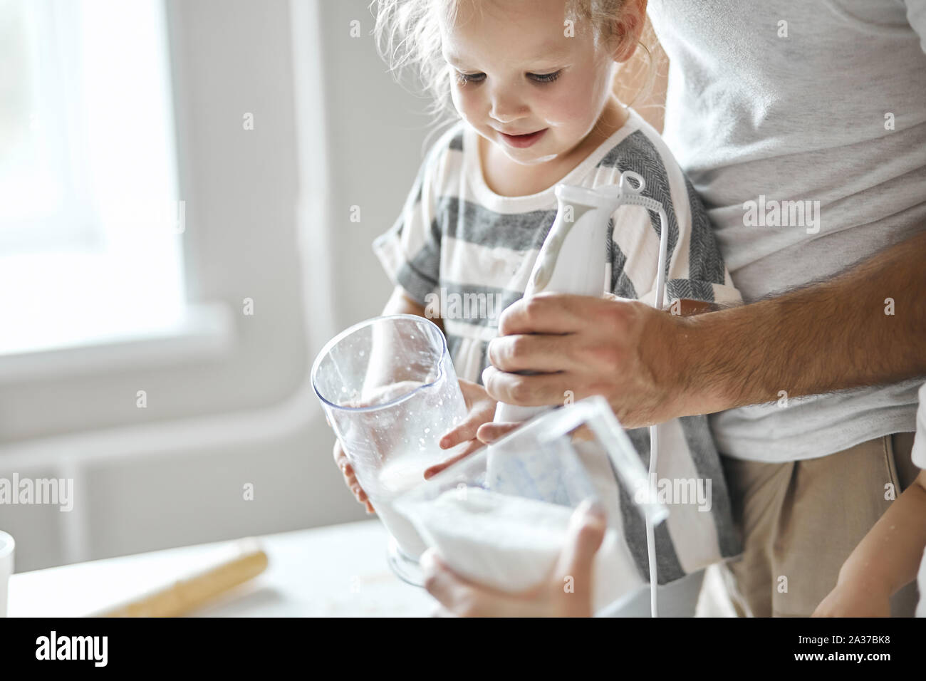 smiling little girl helping her parents about the house, kid doing ...