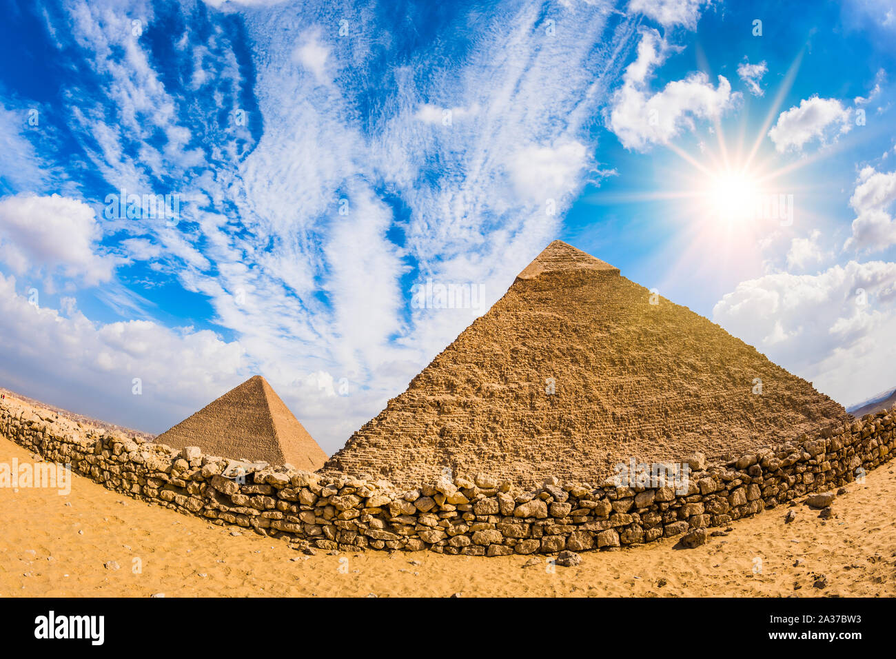 Great Pyramids in Giza, Egypt, with blue sky and bright sun Stock Photo ...