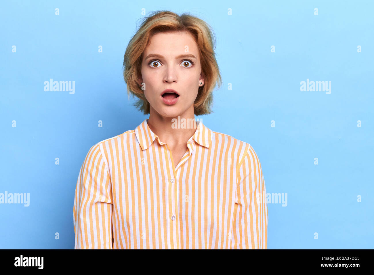 Shocked blonde emotional scared woman with her mouth opened, isolated ...