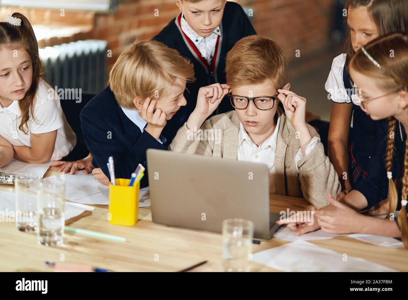 schoolchildren preparing presentation, doing homework, close up photo ...