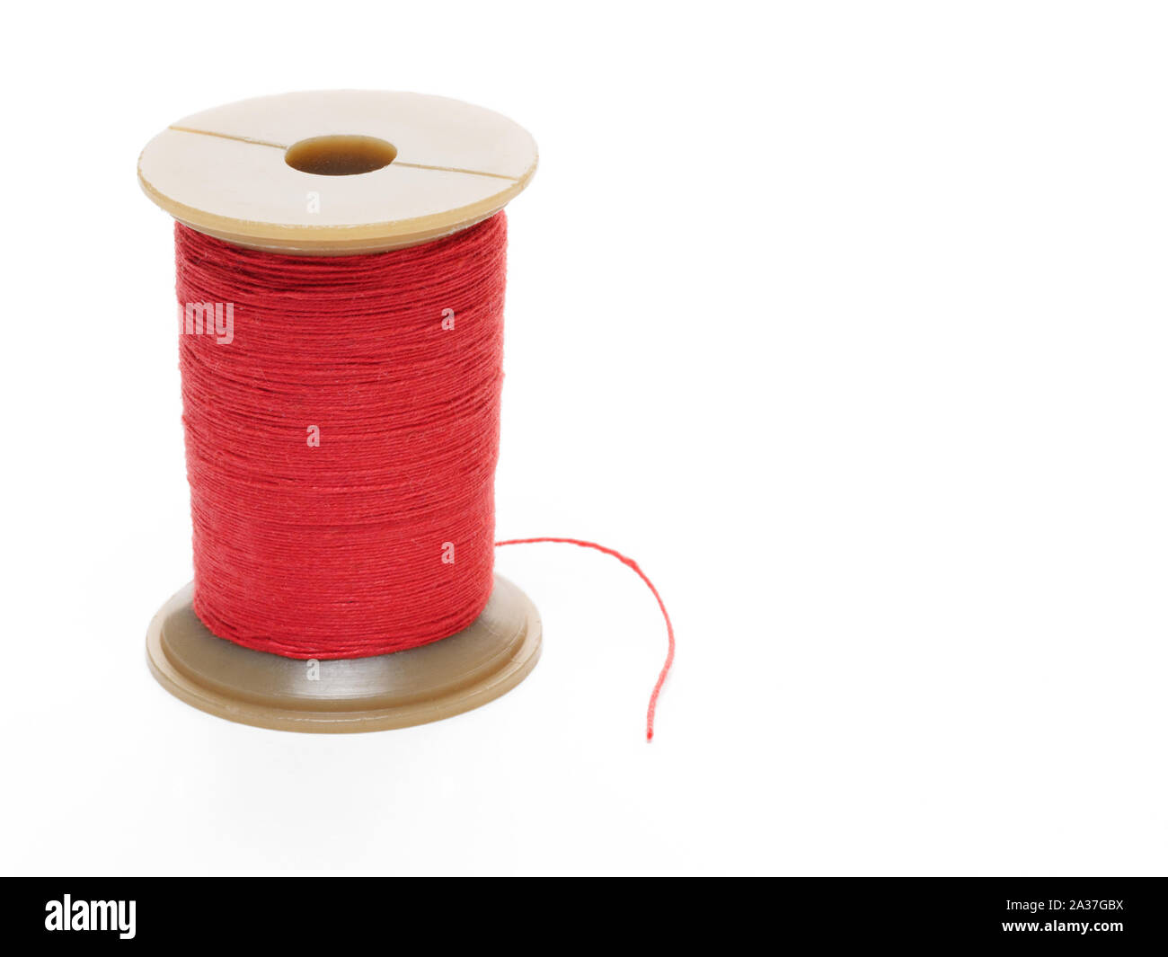 Red spool of thread in a vertical position on a white background Stock ...
