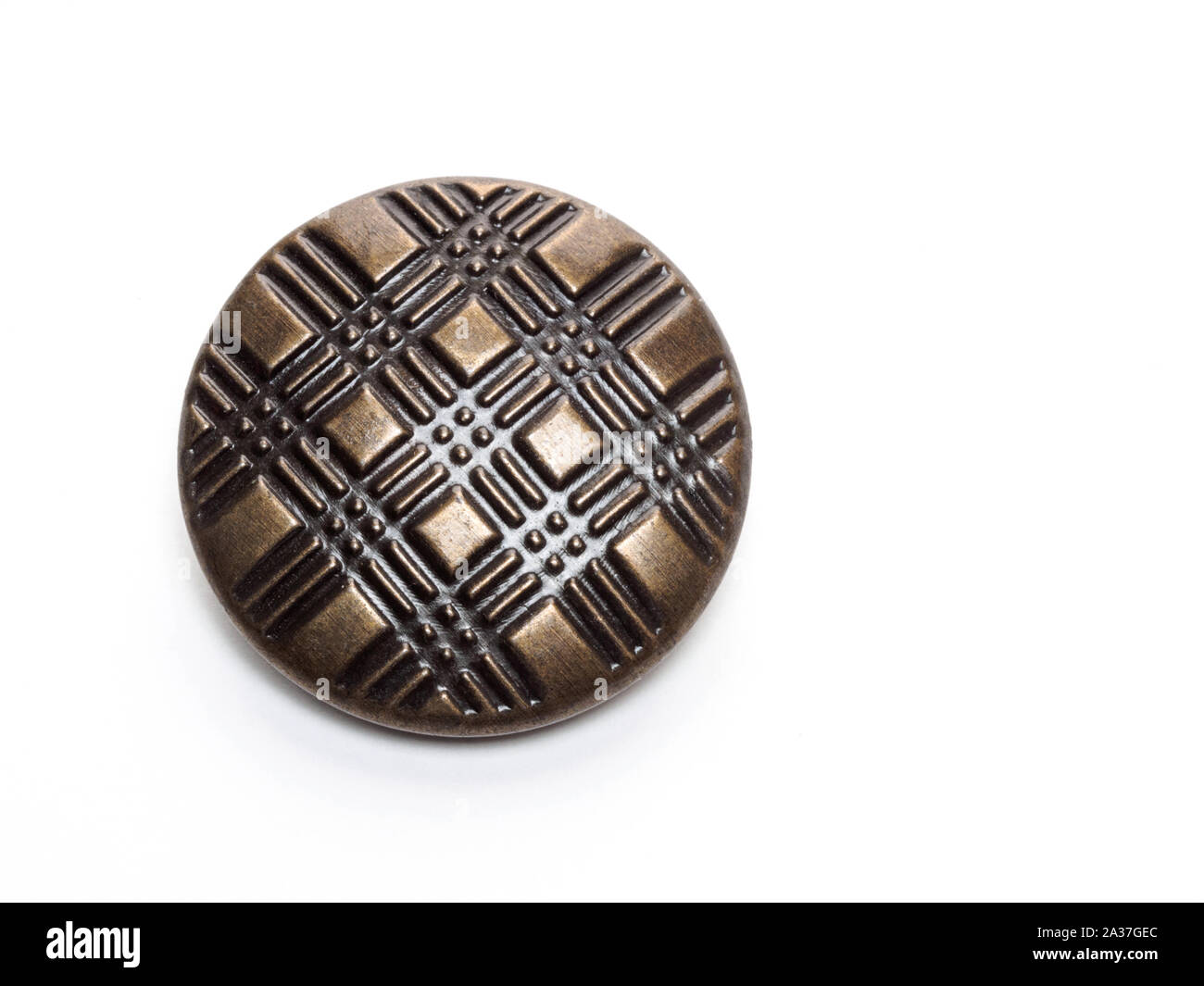 Brown metal button on white background Stock Photo - Alamy