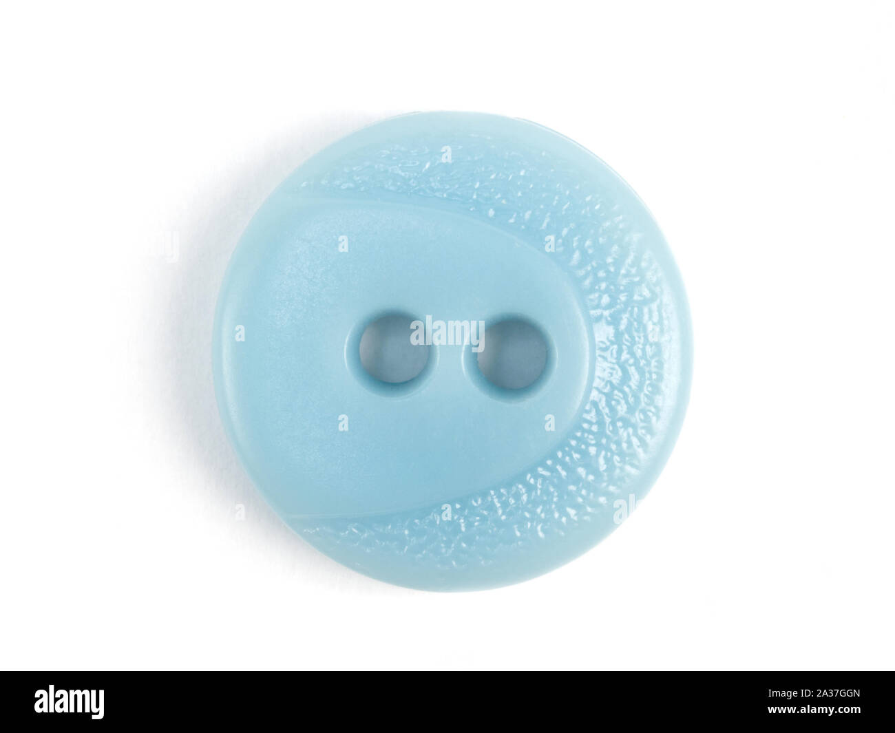 Light blue plastic button on white background Stock Photo - Alamy