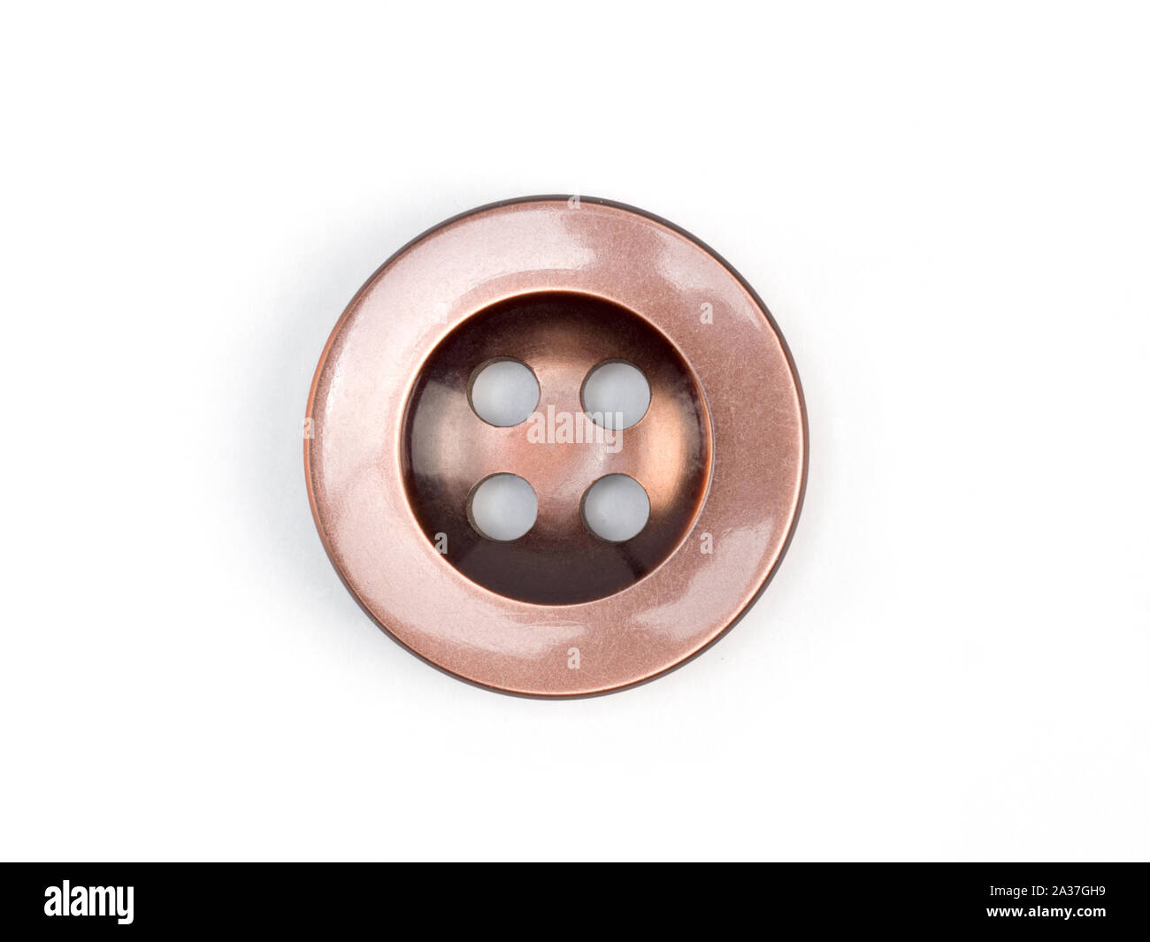Brown plastic button on white background Stock Photo - Alamy