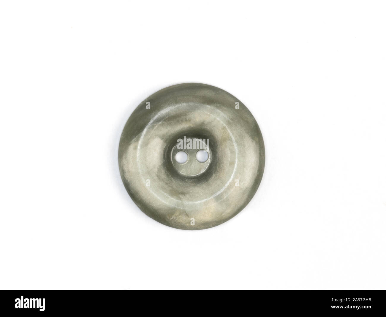Green plastic button on white background Stock Photo - Alamy