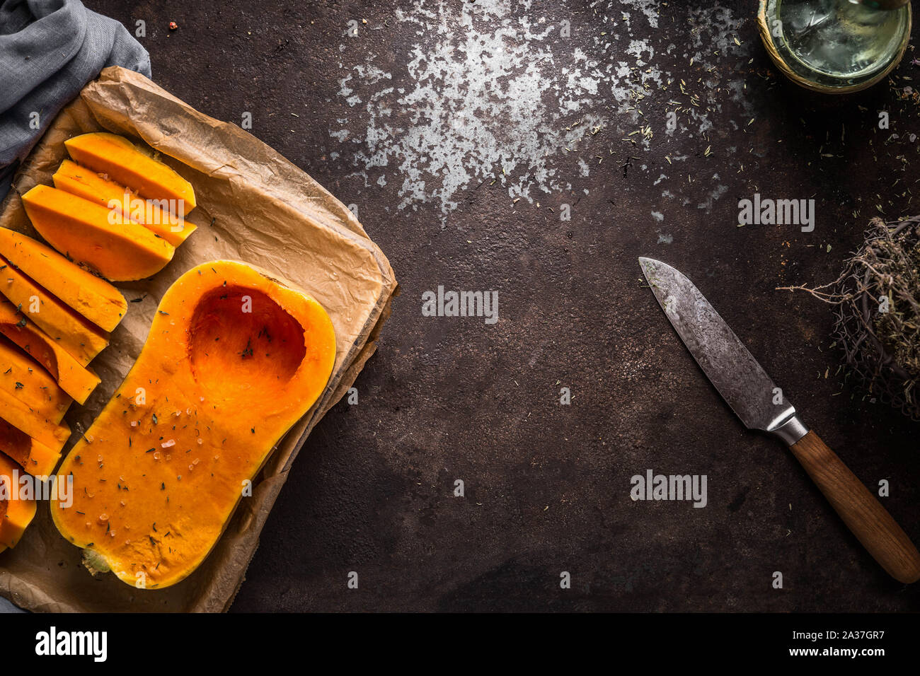 Food background with butternut pumpkin on baking sheet on dark rustic ...