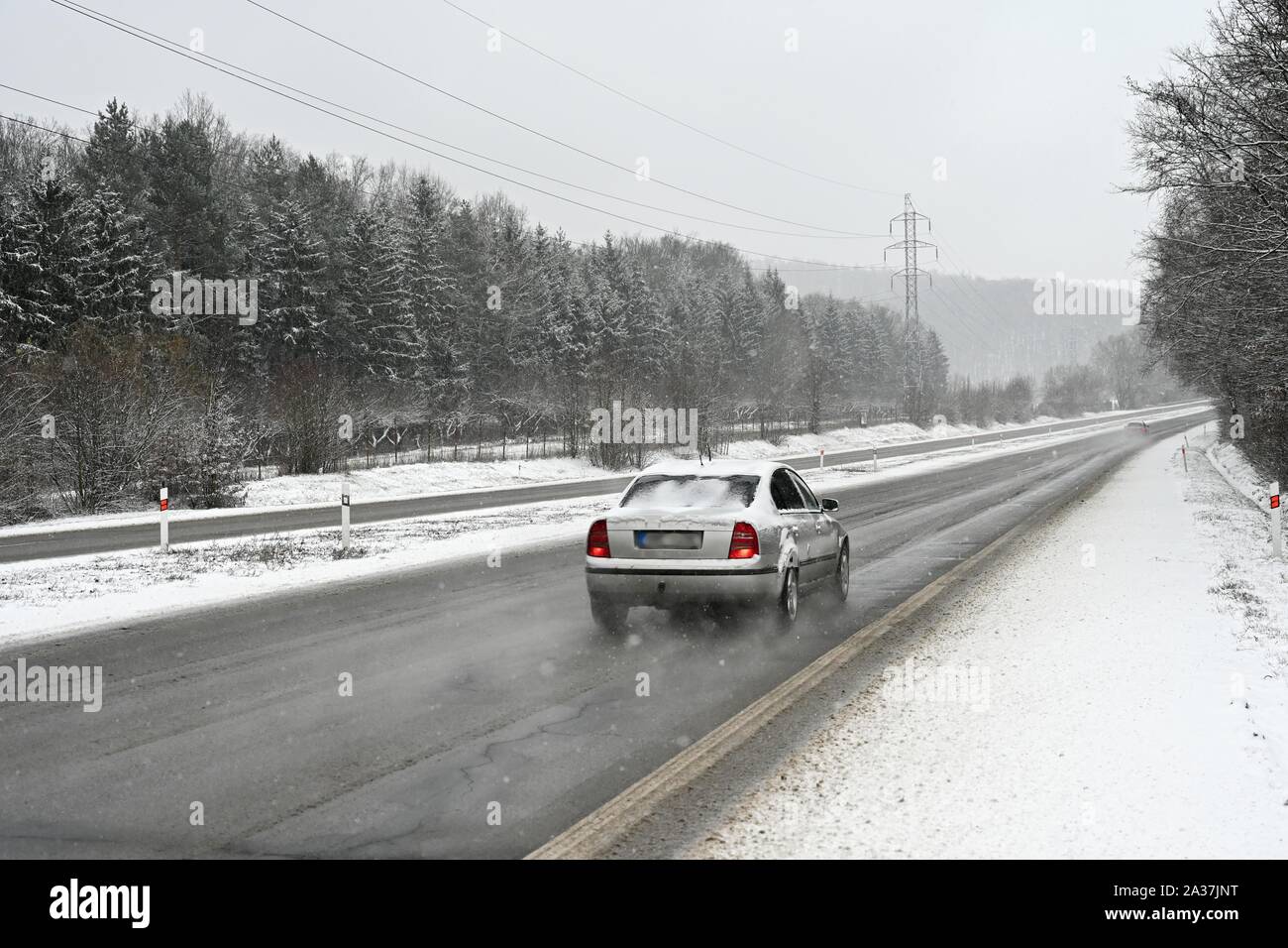 Cars on winter road with snow. Dangerous automobile traffic in bad ...
