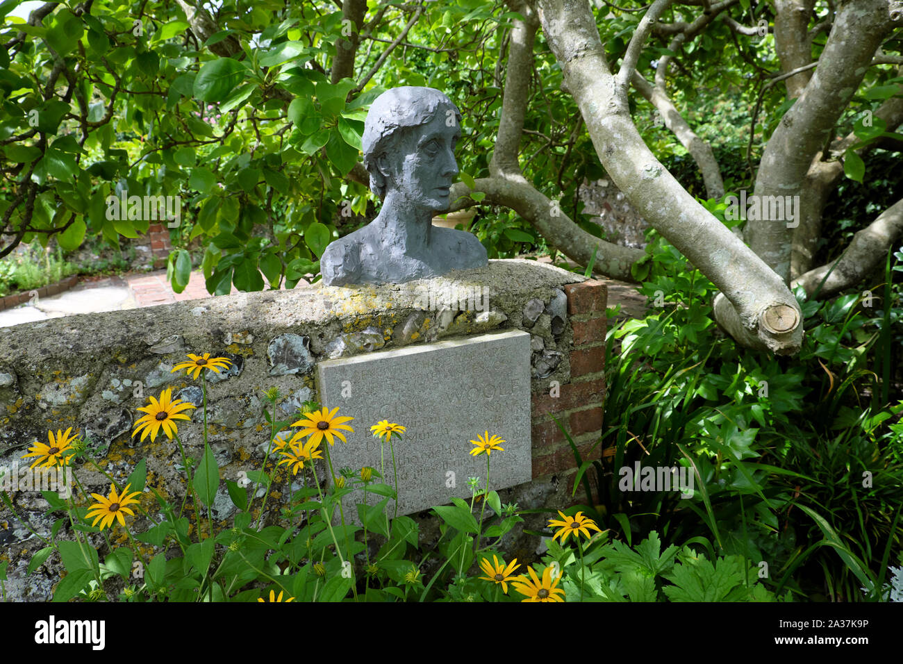 Virginia Woolf sculpture in the garden with yellow rudbeckia flowers ...