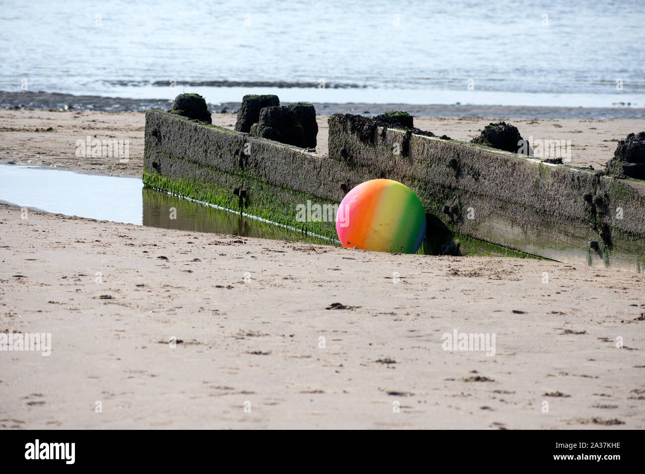 Disused Beach Ball on Beach at Clevelys, UK Stock Photo - Alamy