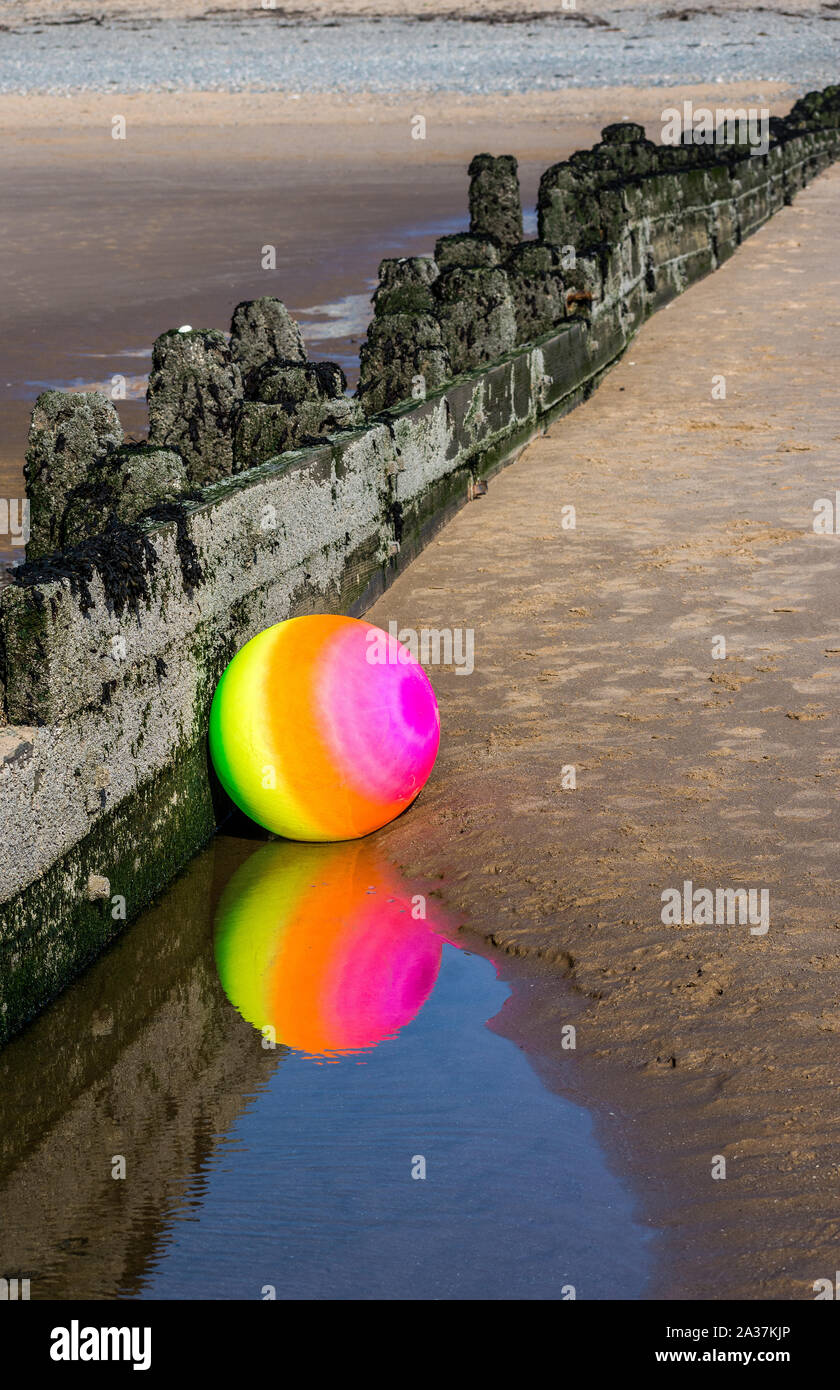 Disused Beach Ball on Beach at Clevelys, UK Stock Photo - Alamy