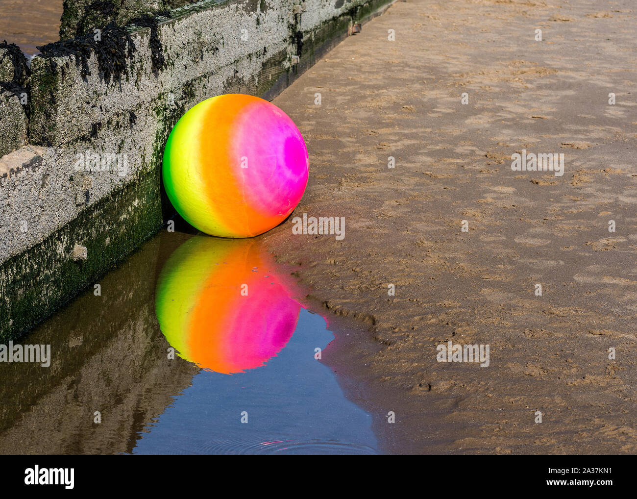 Disused Beach Ball on Beach at Clevelys, UK Stock Photo - Alamy