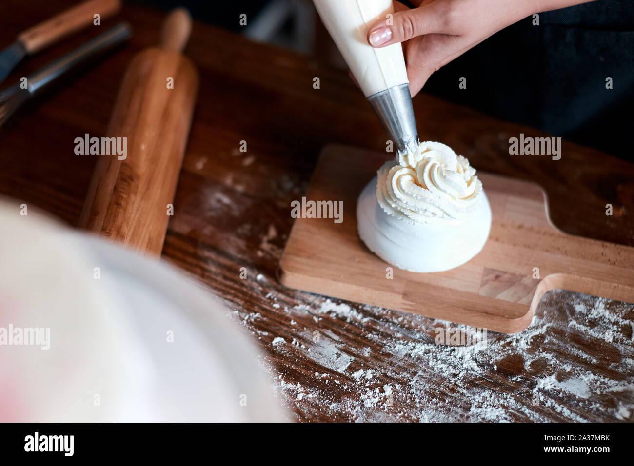 girl applying cream on the cake. close up cropped photo Stock Photo - Alamy