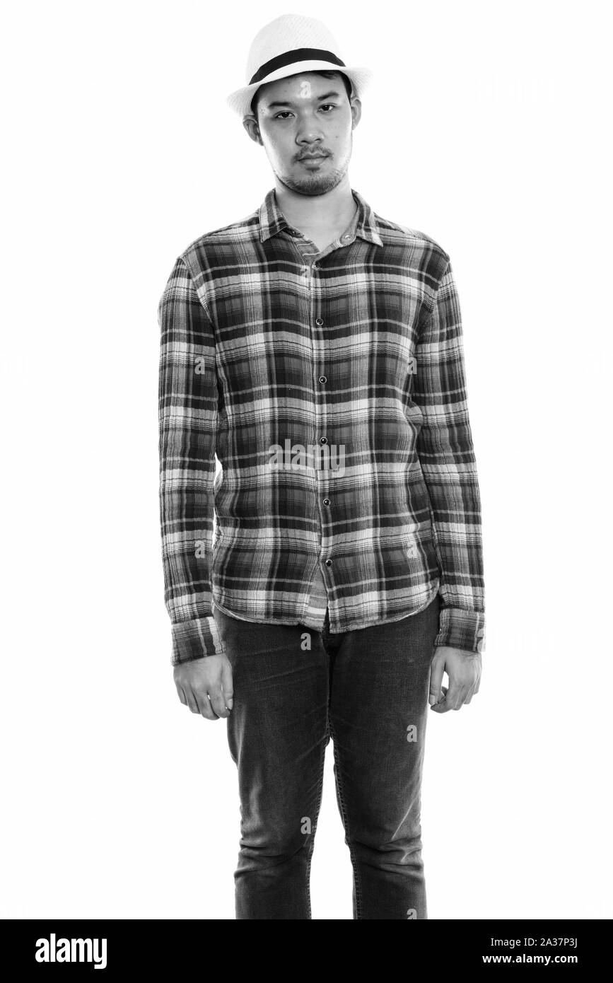 Studio shot of young Asian man standing Stock Photo - Alamy