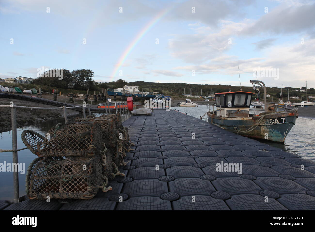 Fishing boat with rainbow, Gwbert, Wales Stock Photo - Alamy