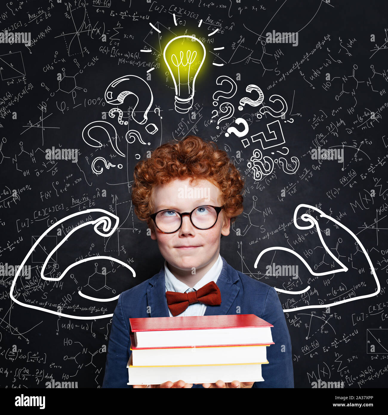Little boy student thinking and looking at lightbulb on blackboard ...