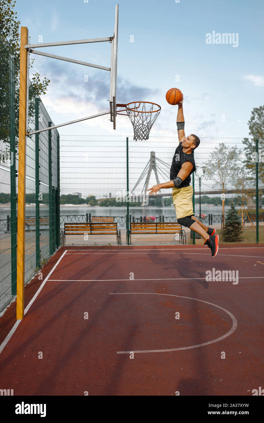 Basketball player makes shoot in jump Stock Photo - Alamy