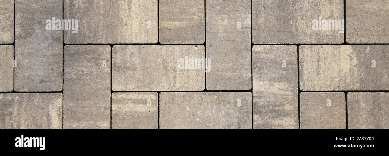 Paving slabs of gray blocks regular shape close-up. New pavement in the ...