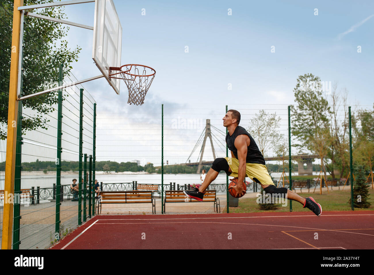Basketball player makes a throw in jump, outdoor Stock Photo - Alamy