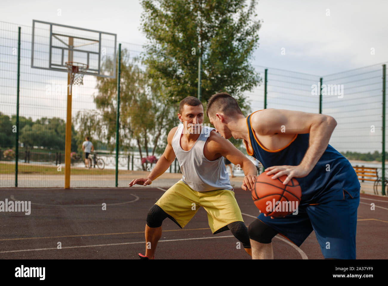 Basketball players playing intense match outdoor Stock Photo - Alamy