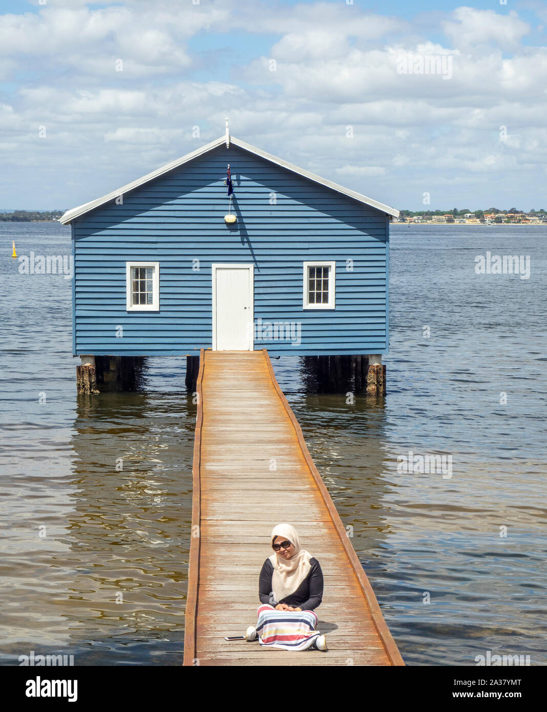Tourist posing for photos of Crawley Blue Boat Shed Swan River Perth ...