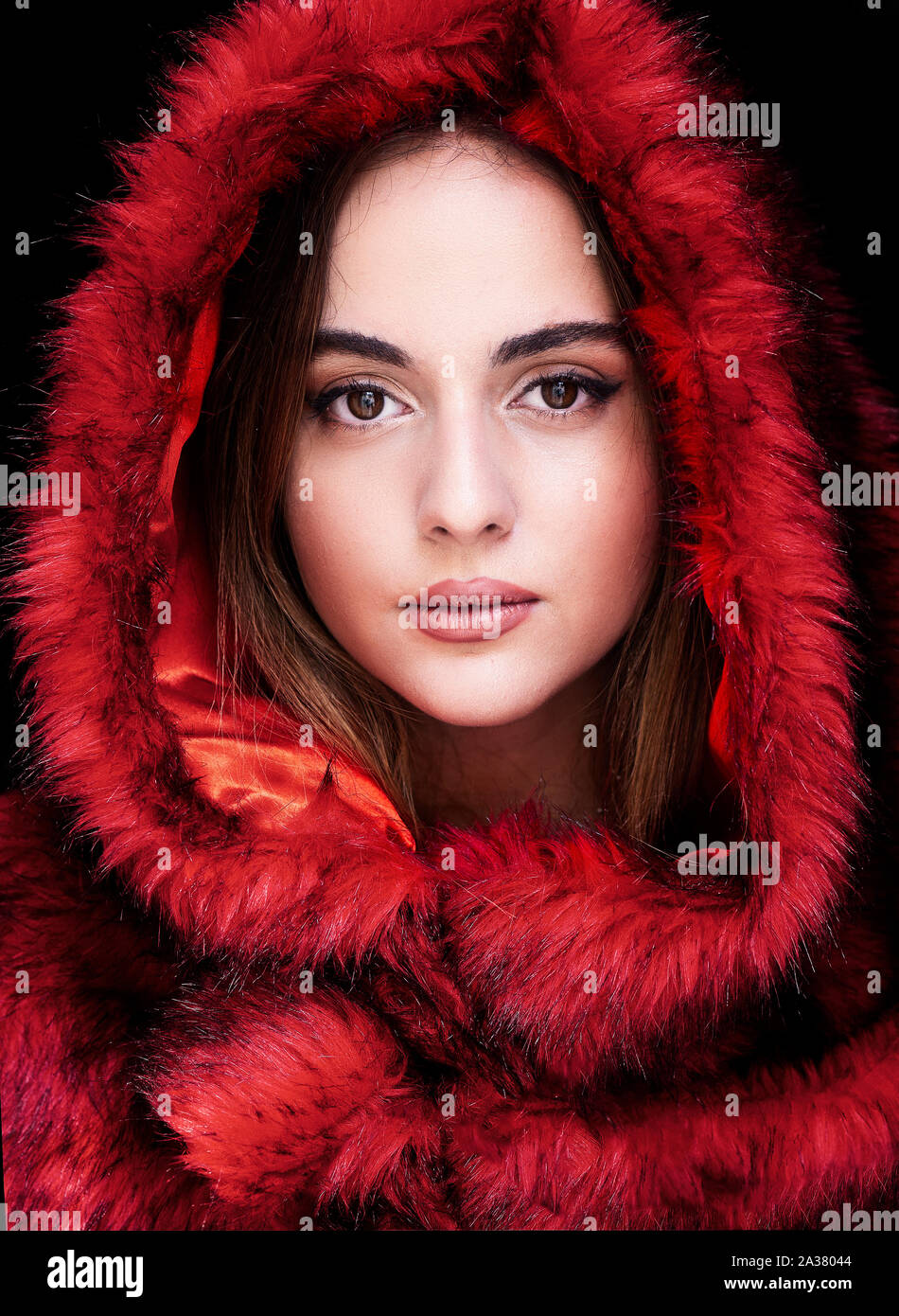Beautiful young woman wearing red fur coat Stock Photo - Alamy