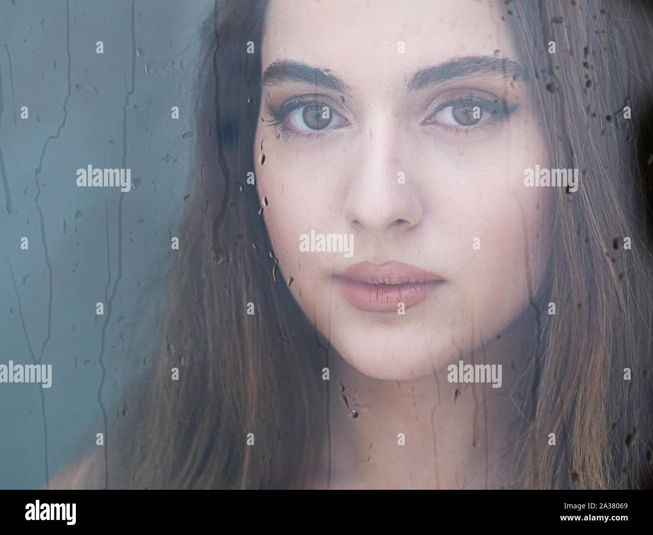 Woman behind wet window hi-res stock photography and images - Alamy