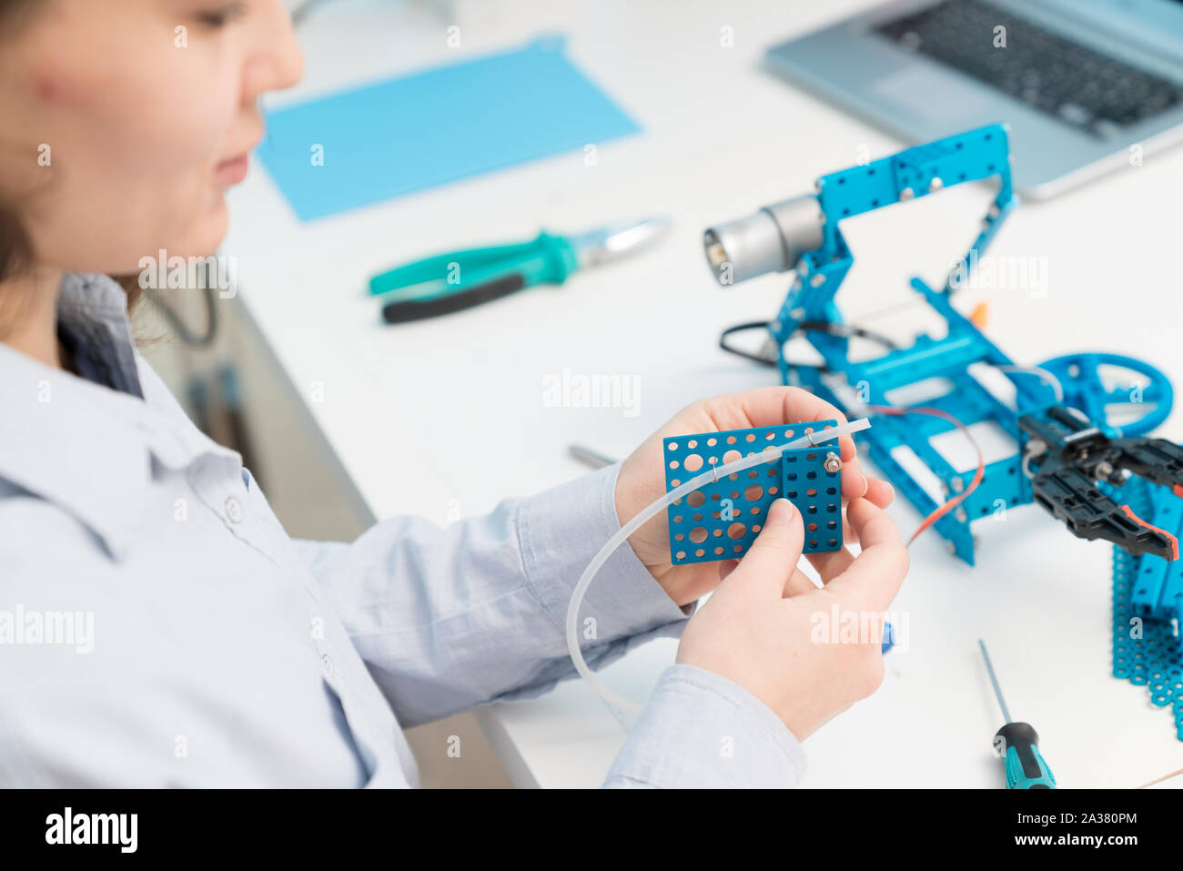 Student woman in robotics laboratory working on project mechatronics ...