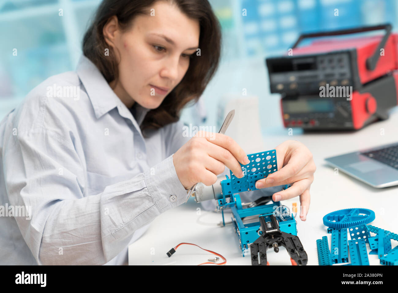Student woman in robotics laboratory working on project mechatronics ...