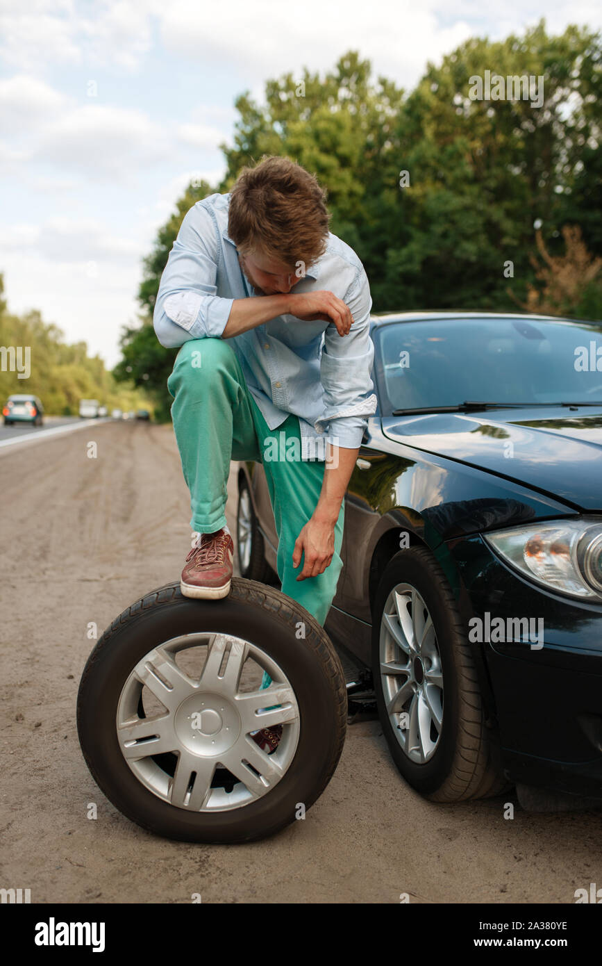 Young driver flat tyre hi-res stock photography and images - Alamy