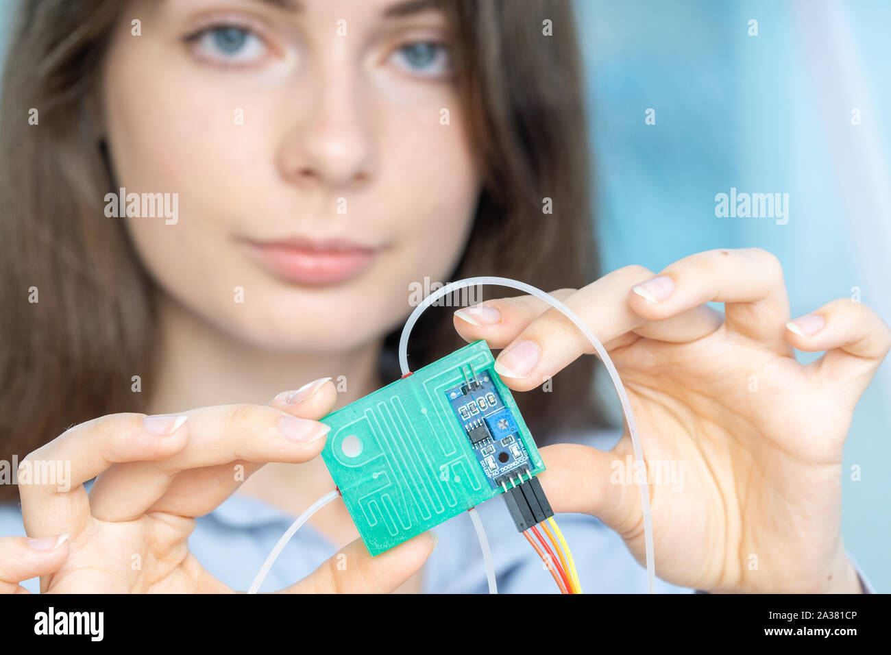 Young scientist woman in microbiological lab with lab-on-chip LOC ...