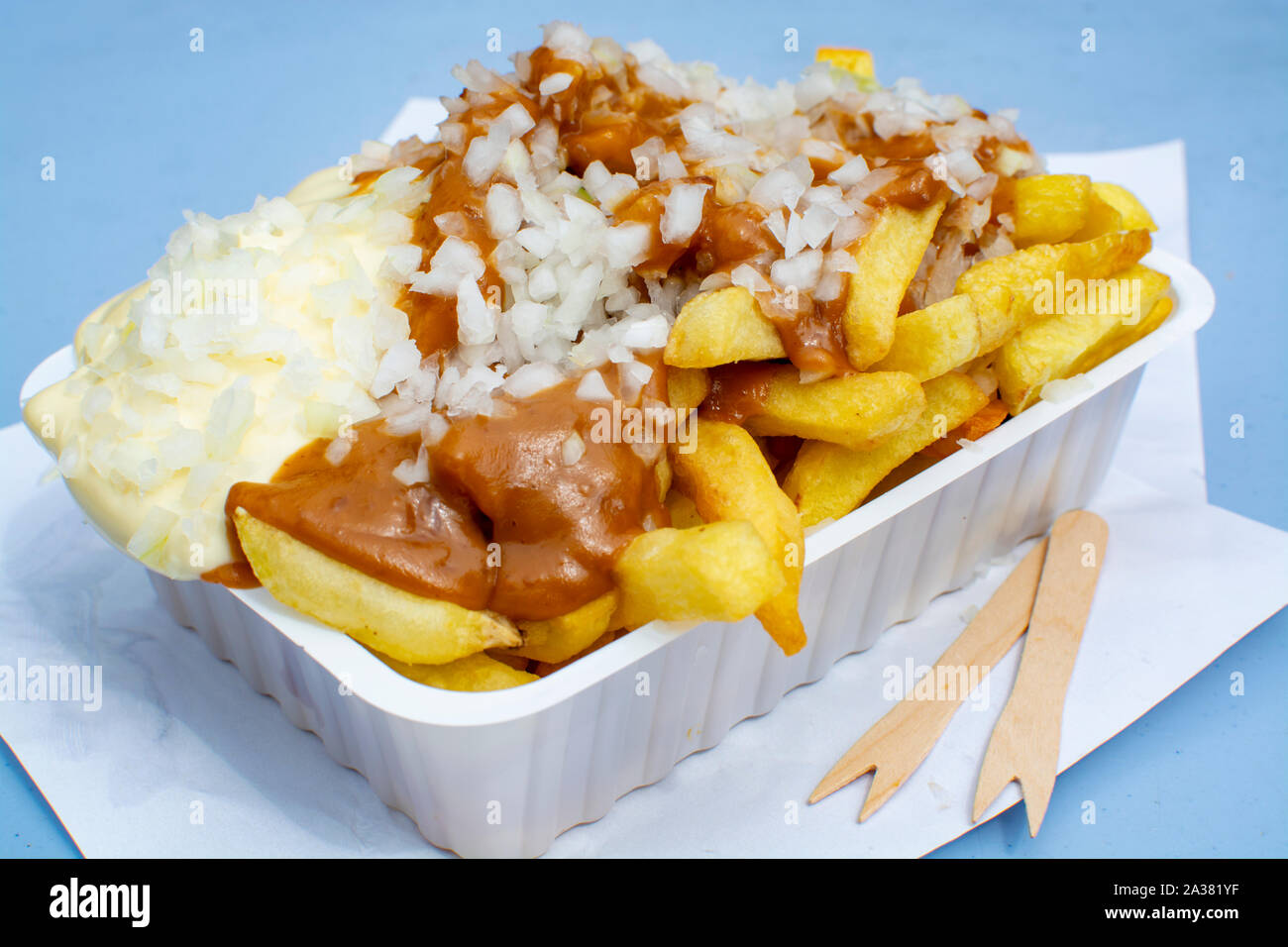 Traditional Dutch fast food dish, fried potatoes with sate sauce, onion ...
