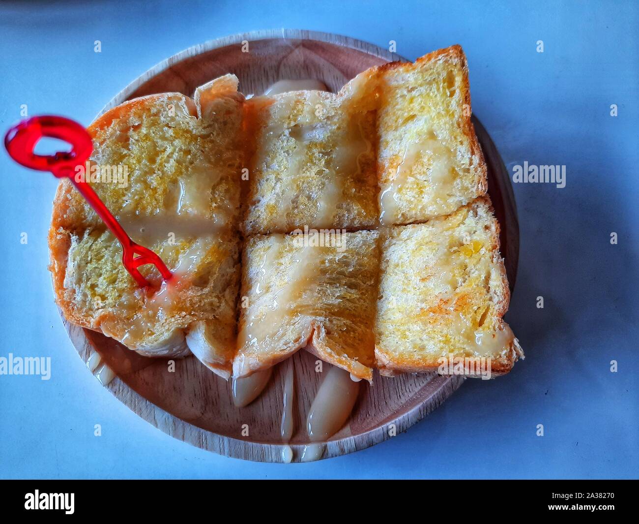 The Crusty Bread Toast Slice with caramel On wooden plate Background ...