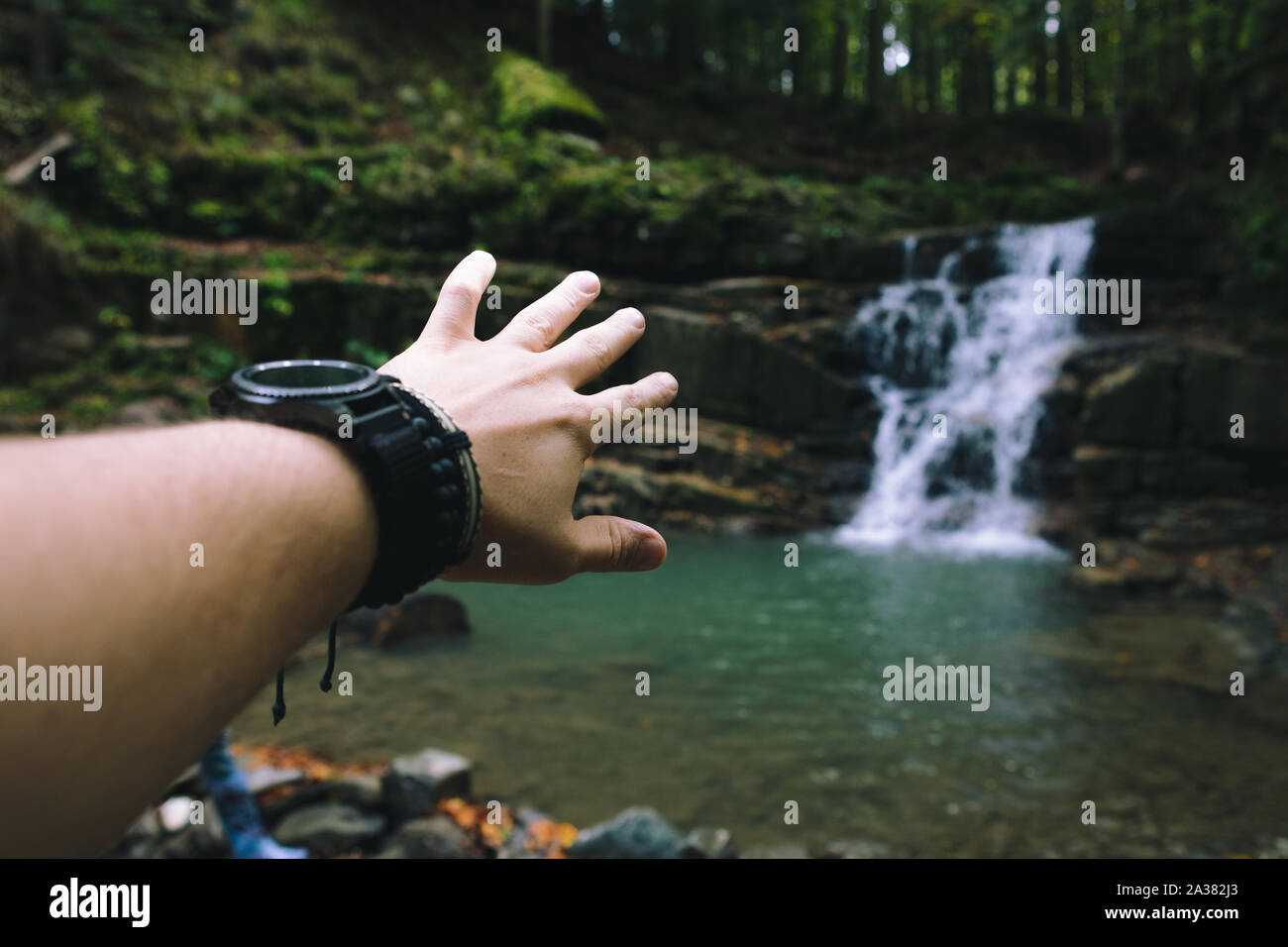 first person view man hands showing waterfall Stock Photo - Alamy