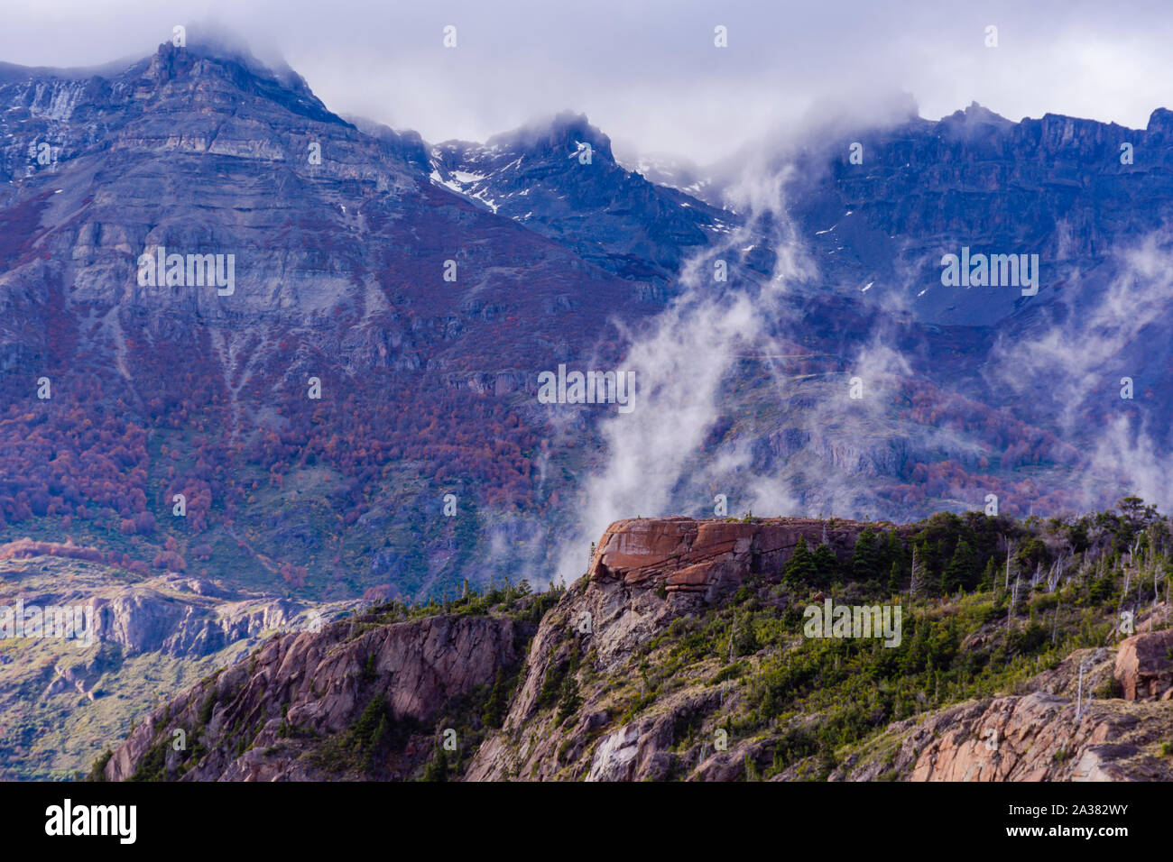 Landscape view of a mountain peak and ascending clouds behind it Stock ...