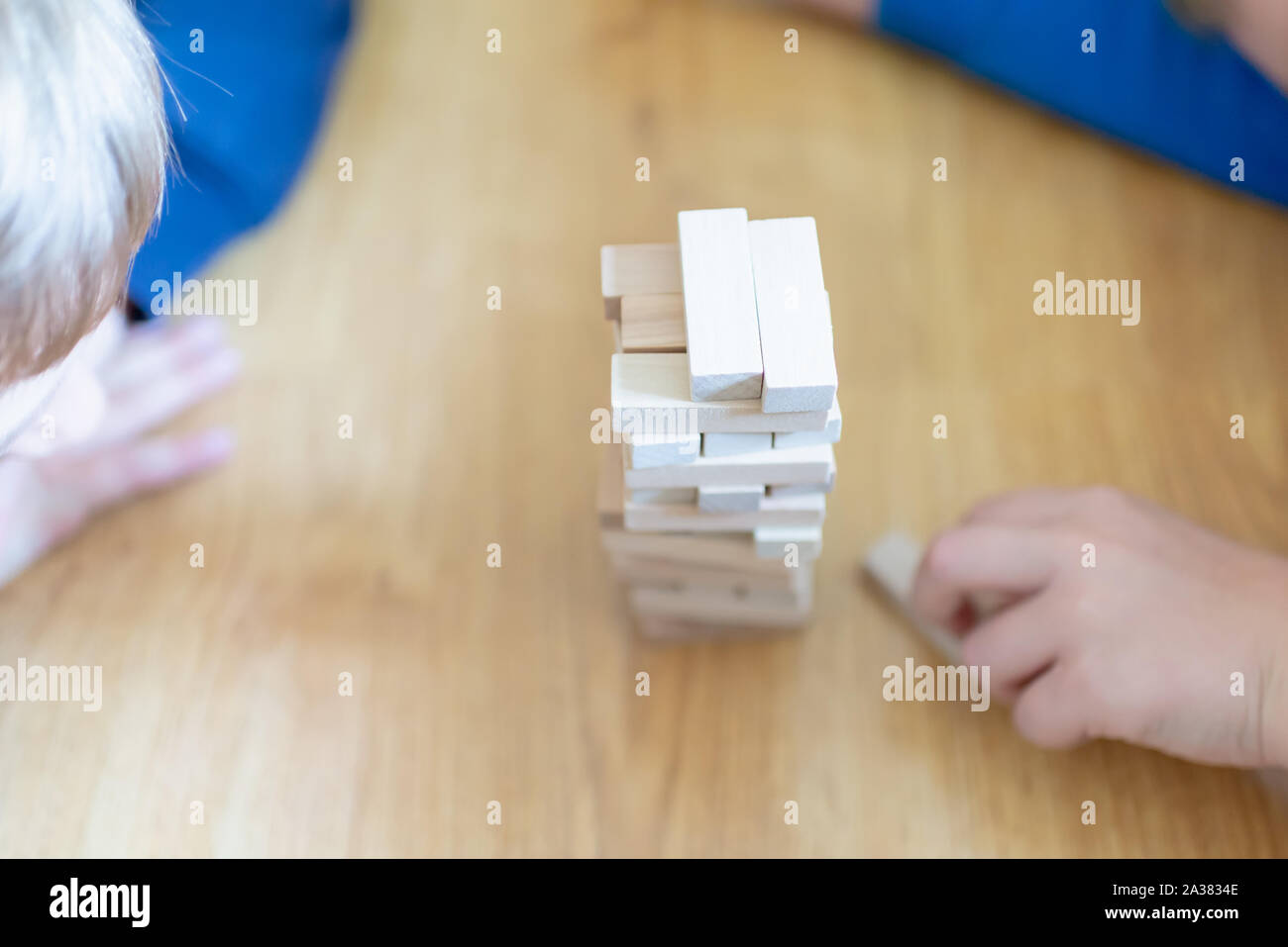 Children are playing jenga, a wood blocks tower game for practicing ...