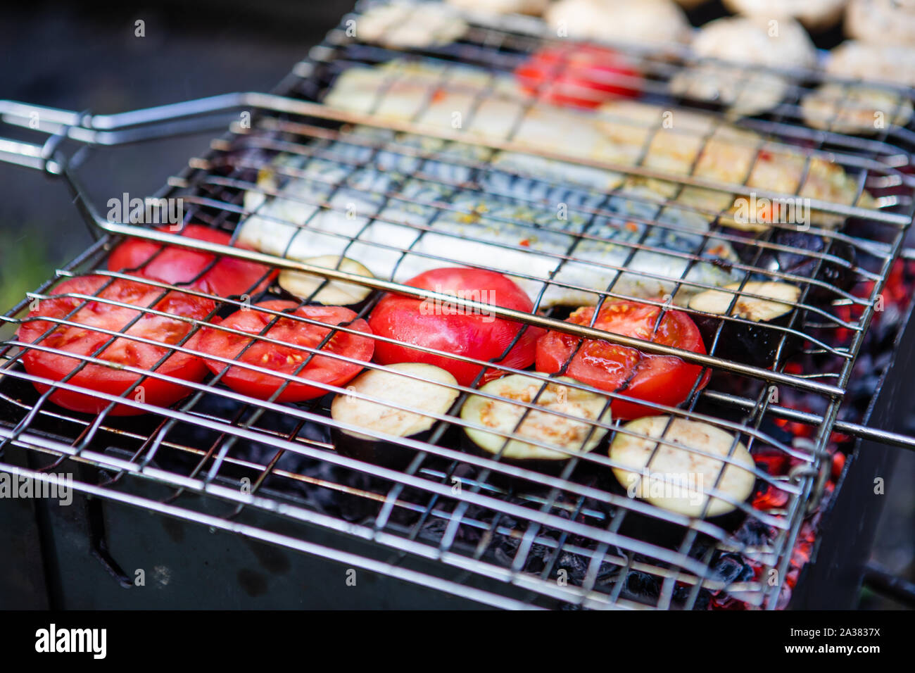bbq concept fish on fire with mushroom and tomatoes Stock Photo - Alamy