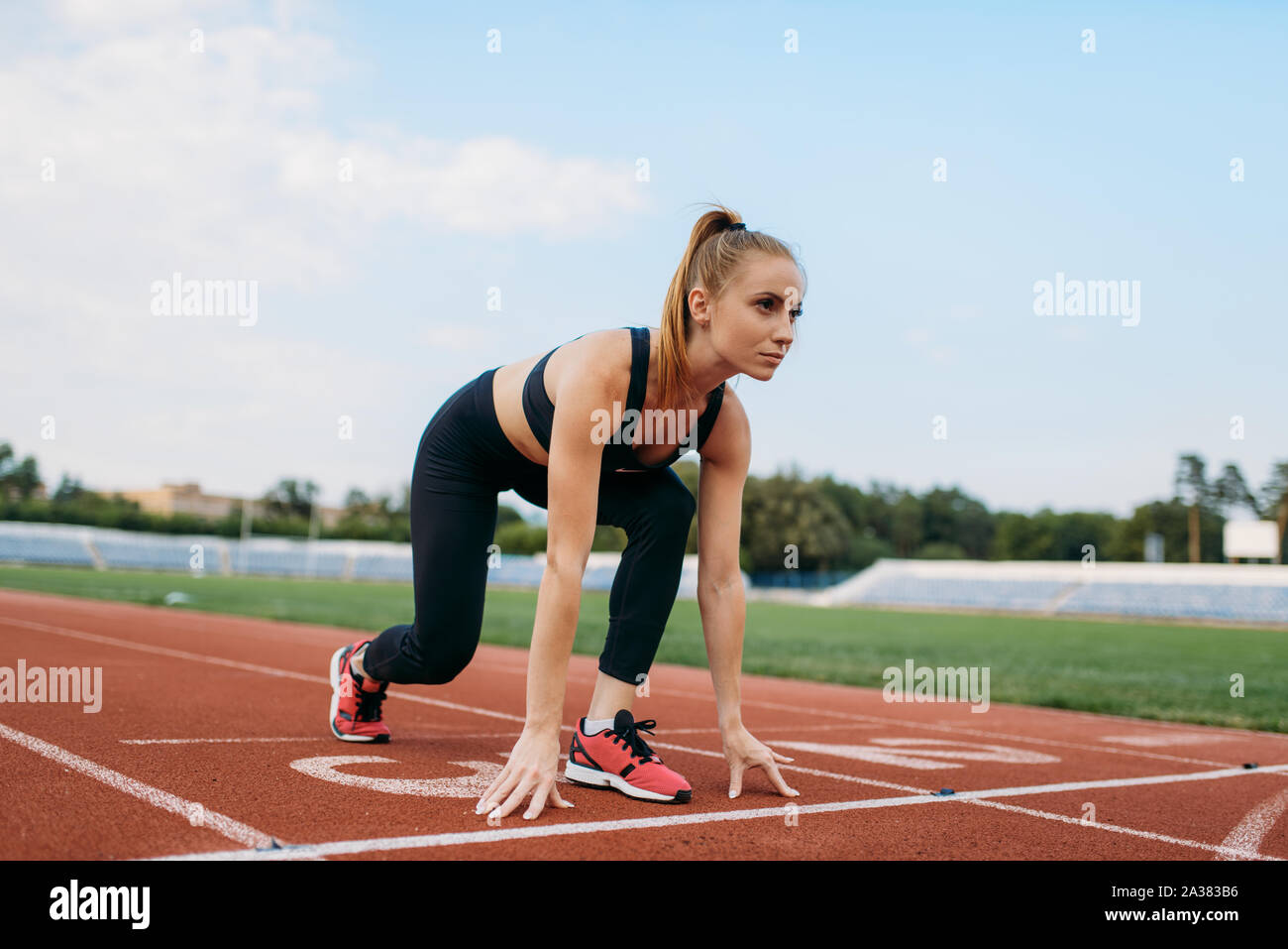 Female runner on start line, training on stadium Stock Photo - Alamy
