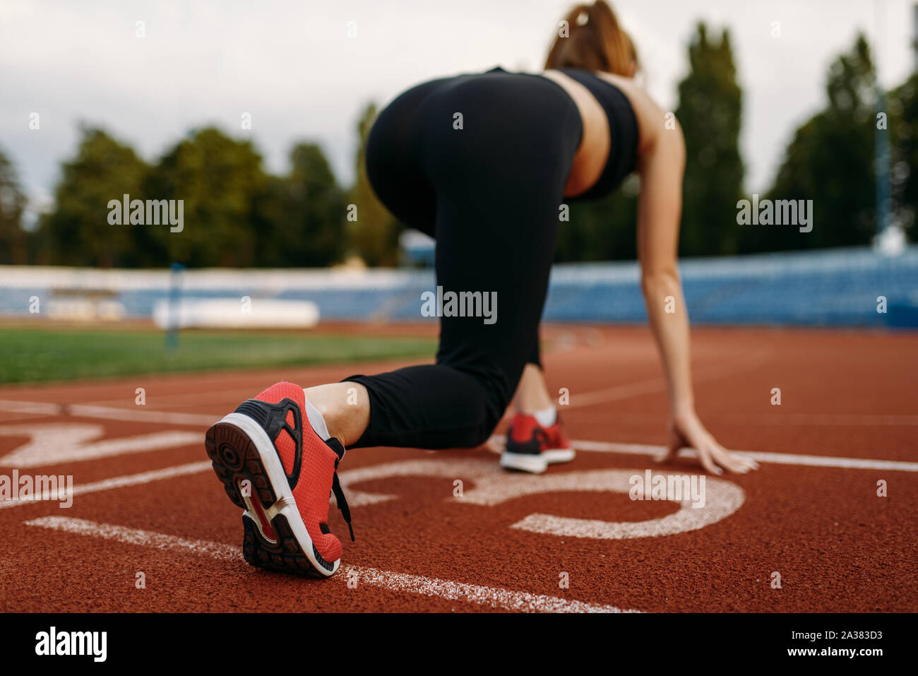 Female runner on start line, training on stadium Stock Photo - Alamy