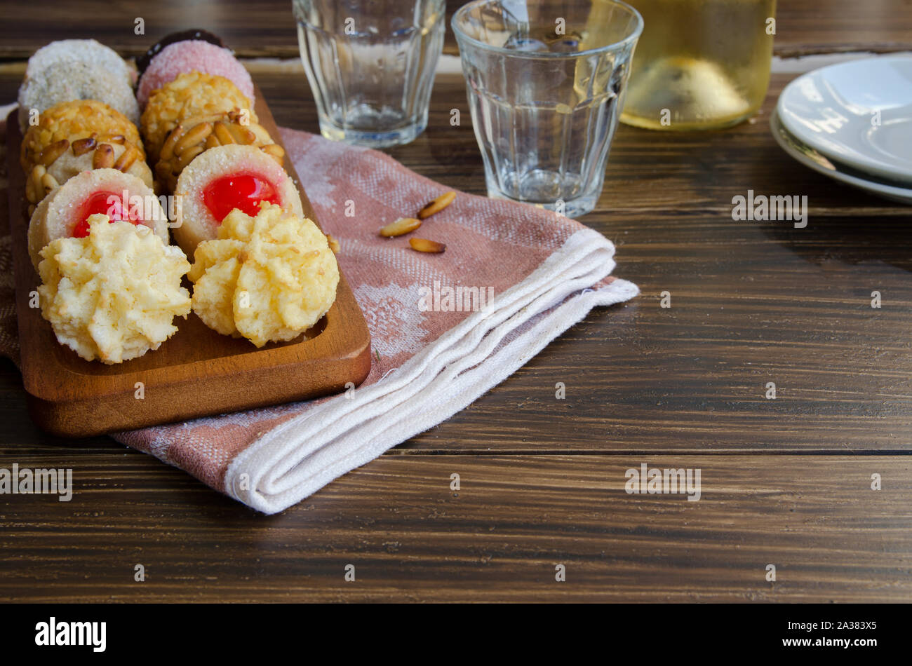 Panellets, different Catalan small cakes, served with sweet white wine ...