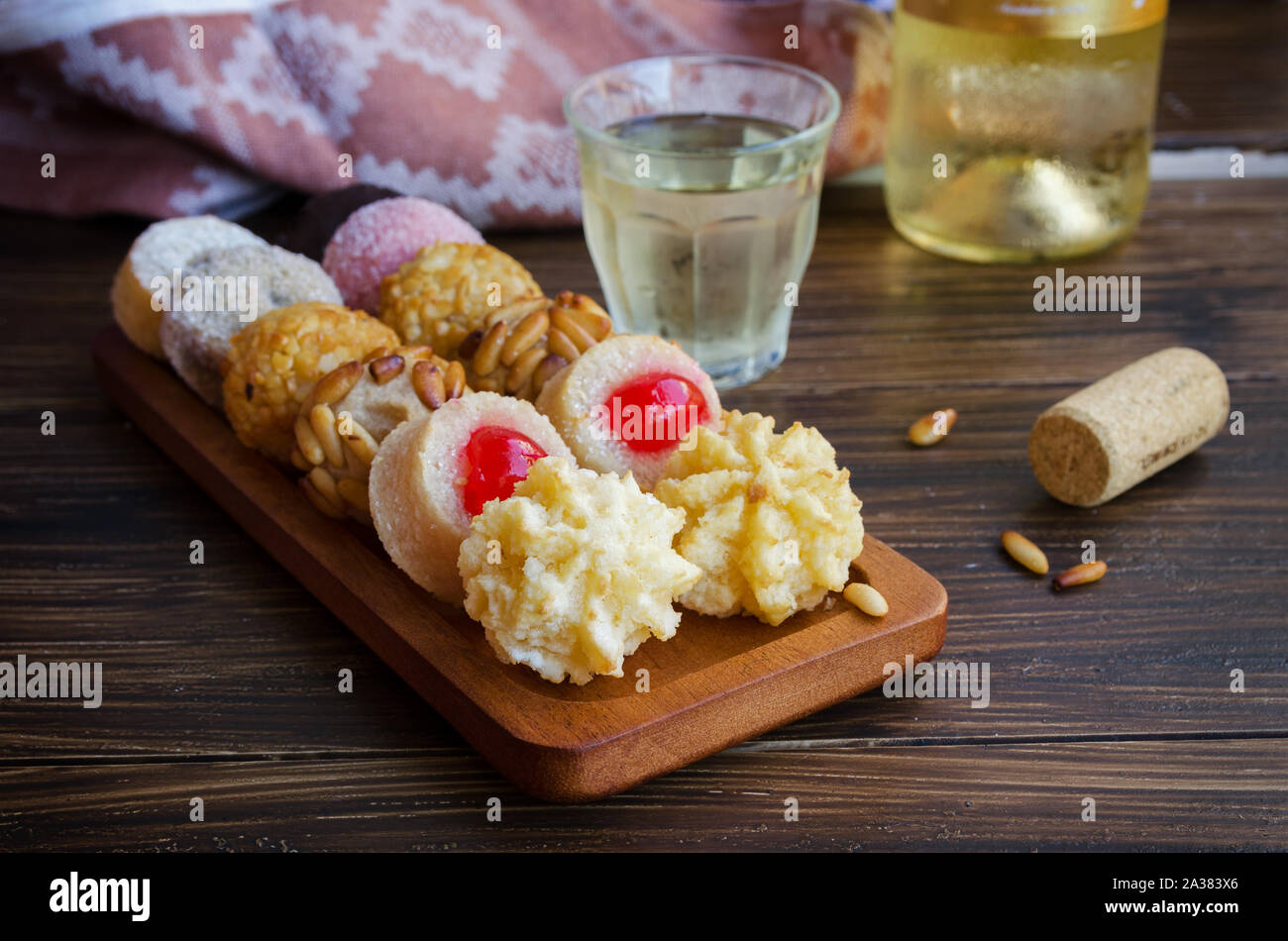 Panellets, different Catalan small cakes, served with sweet white wine ...