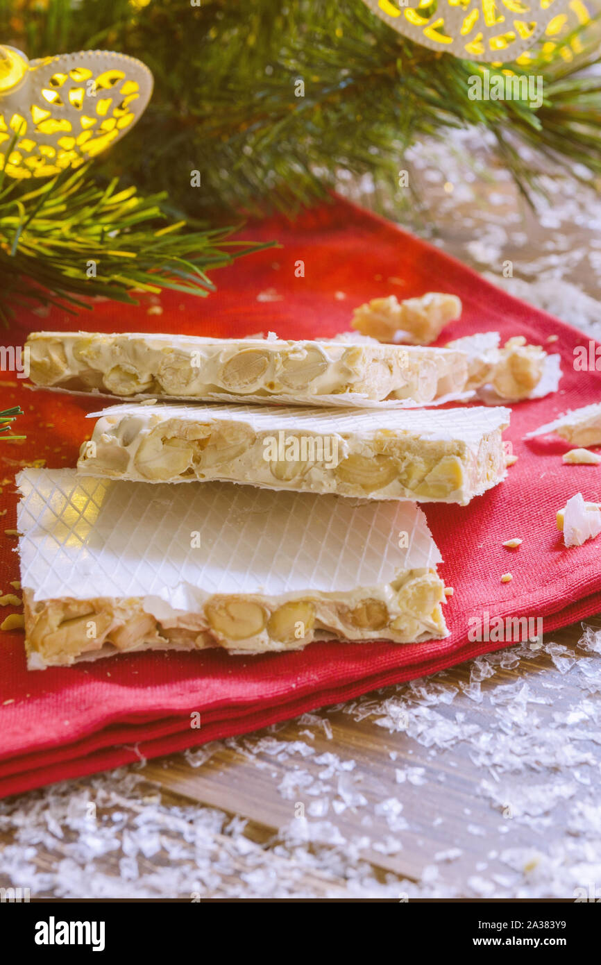 Turron, typical Christmas sweet in Spain. Almond nougat on red napkin ...