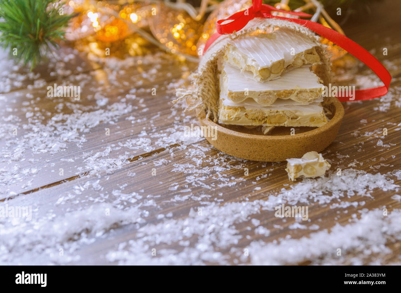Turron, typical Christmas sweet in Spain. Almond nougat on red napkin ...