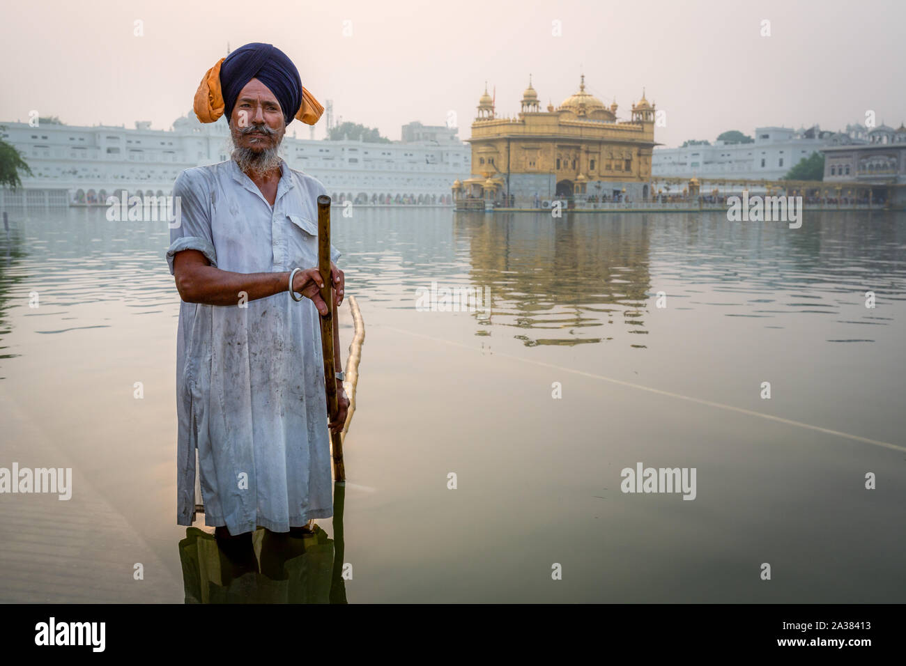 A Sikh cleans the Sarovar (water tank) – around the Golden Temple (Sri ...