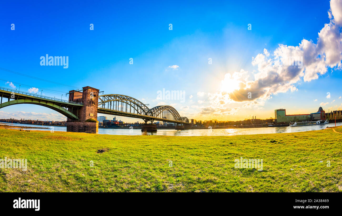 Beautiful place in Cologne, meadow at the Rhine River in bright ...