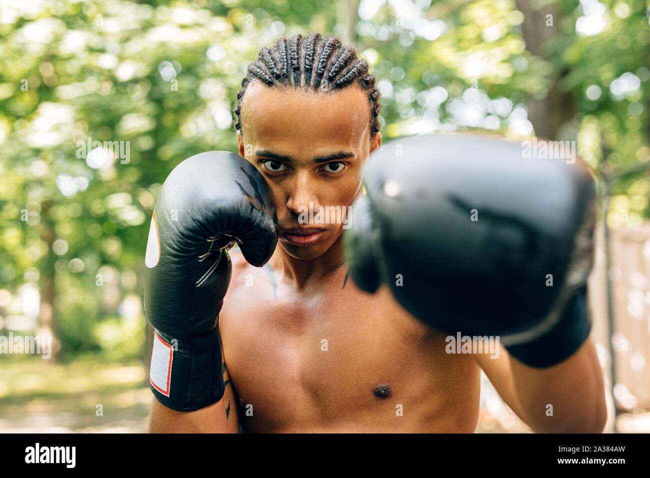 Athlete practicing punches outdoors on sports ground. Close up of a ...