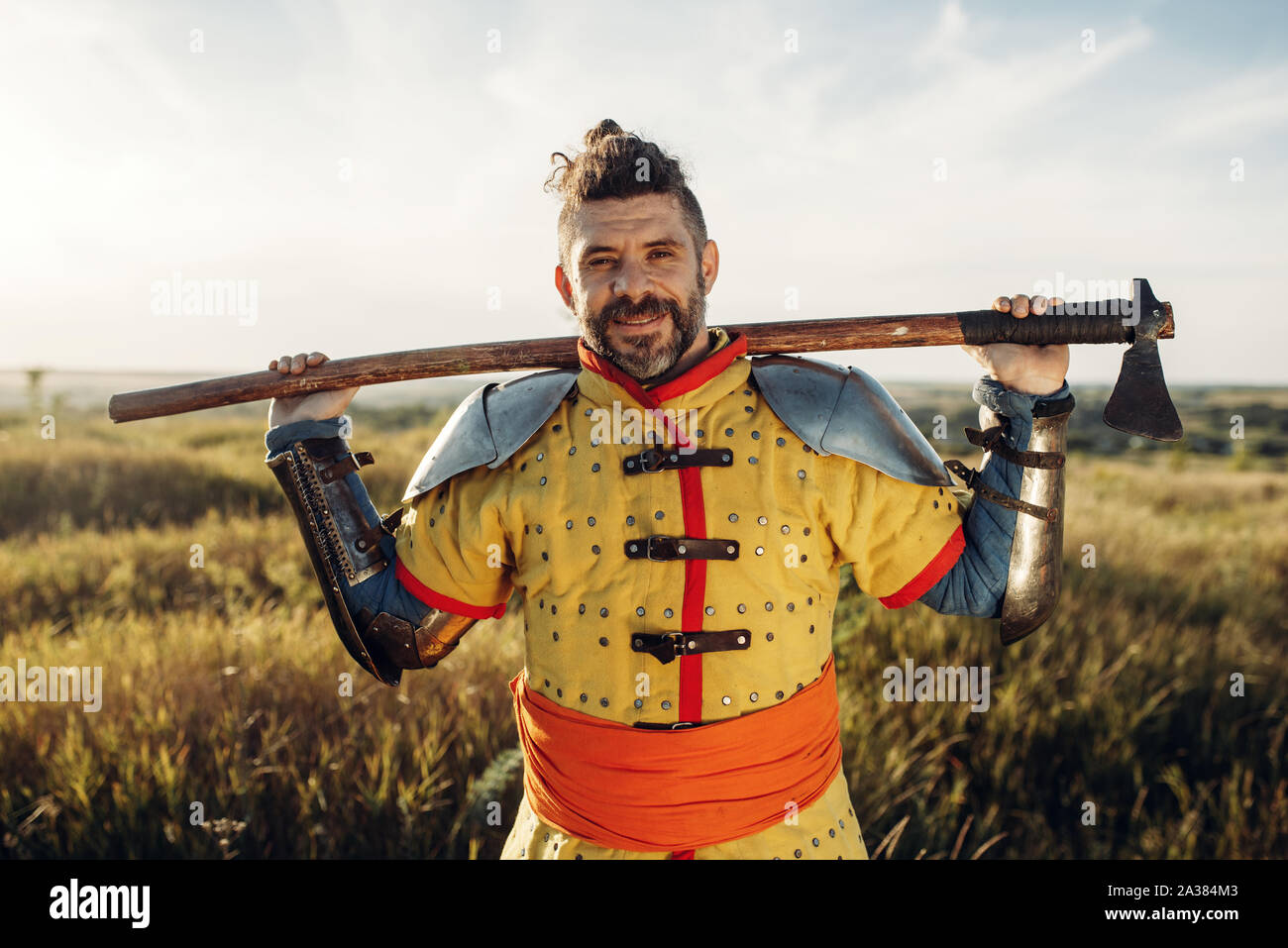 Medieval knight with axe poses in armor Stock Photo - Alamy
