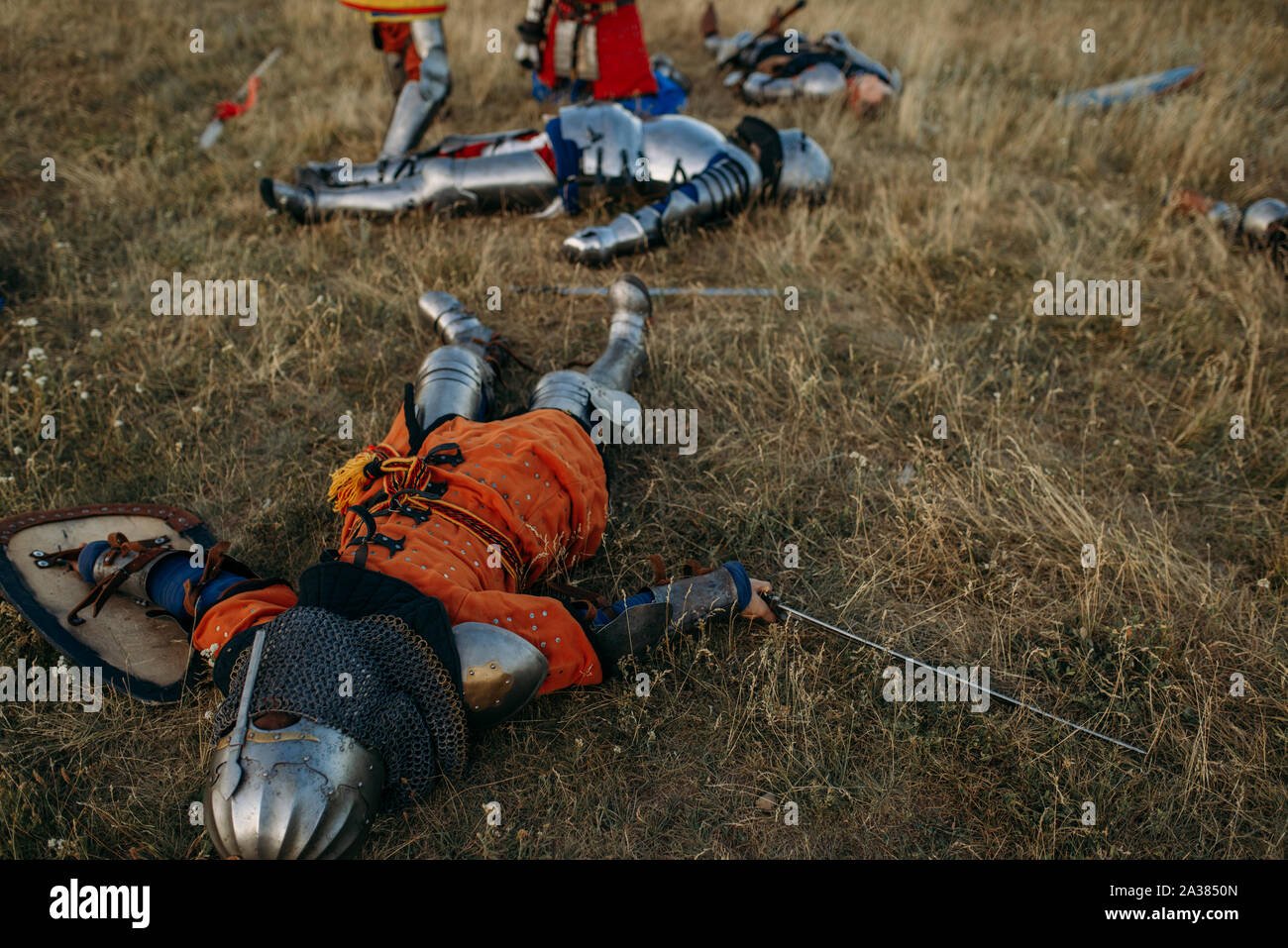 Old medieval knight in armor swings his sword Stock Photo - Alamy