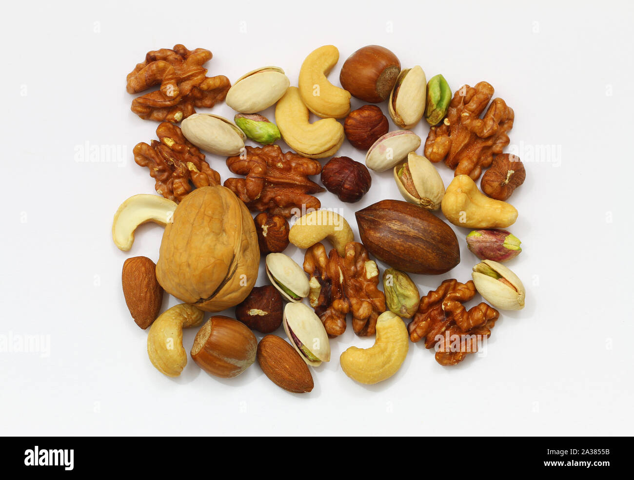 Selection of nuts with and without shell on white surface Stock Photo ...